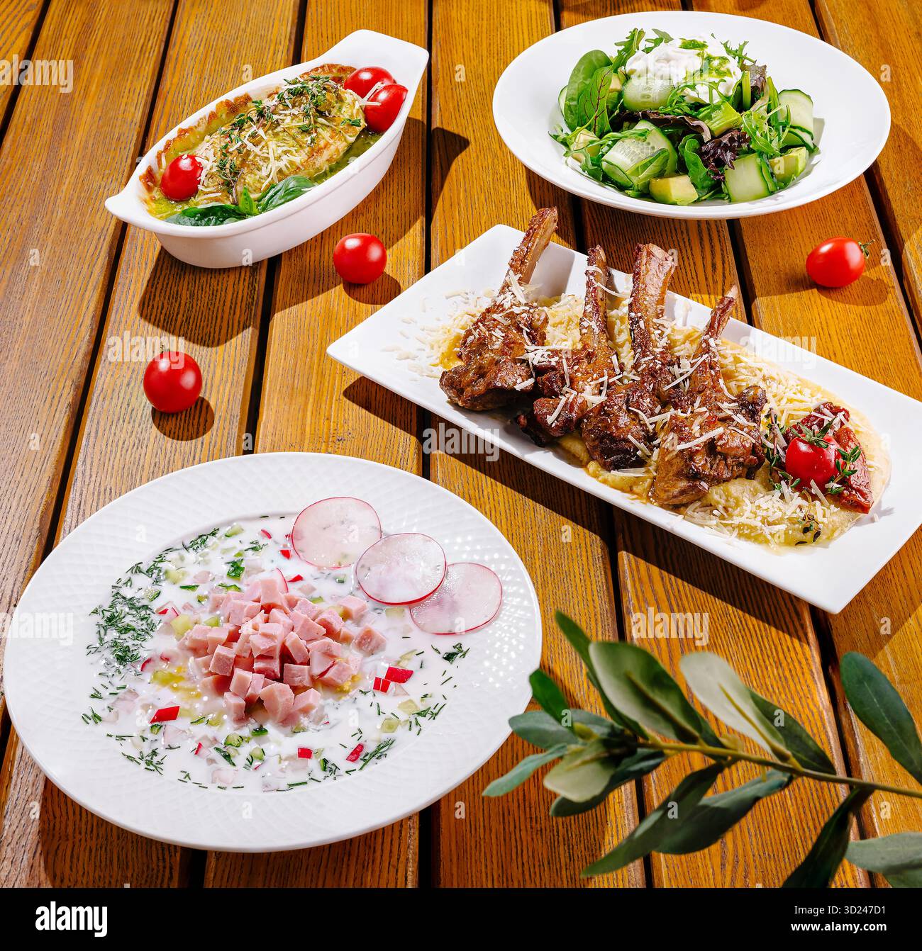 Delicious dinner spread featuring grilled lamb, salad, and baked dish ...