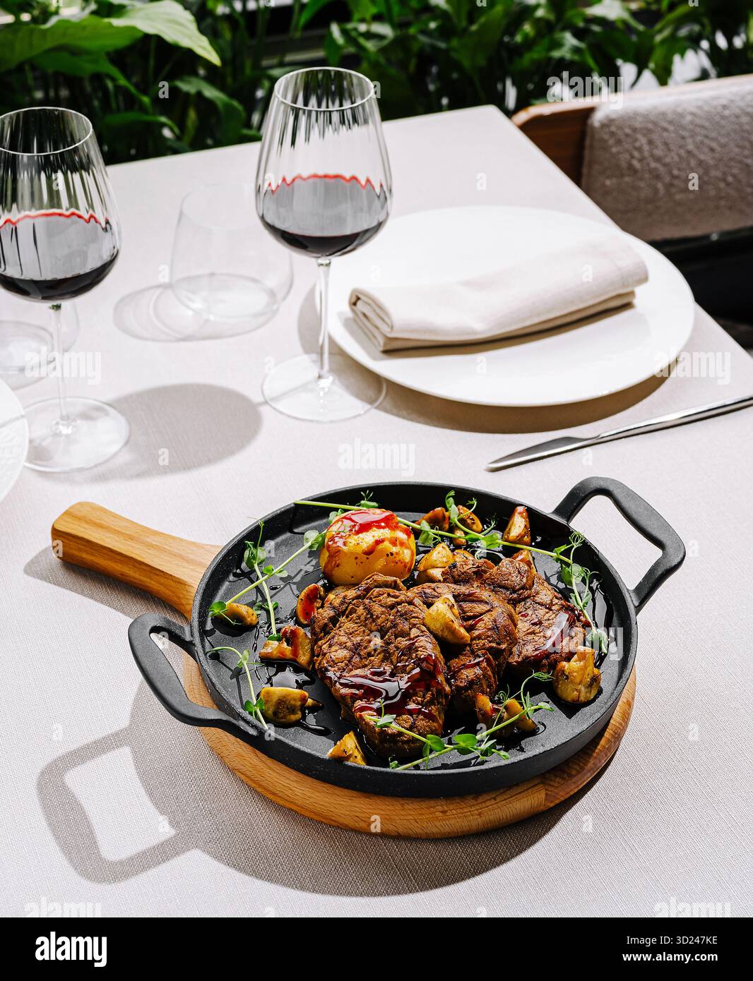 Juicy steaks rest on a sizzling cast iron pan, surrounded by colorful ...