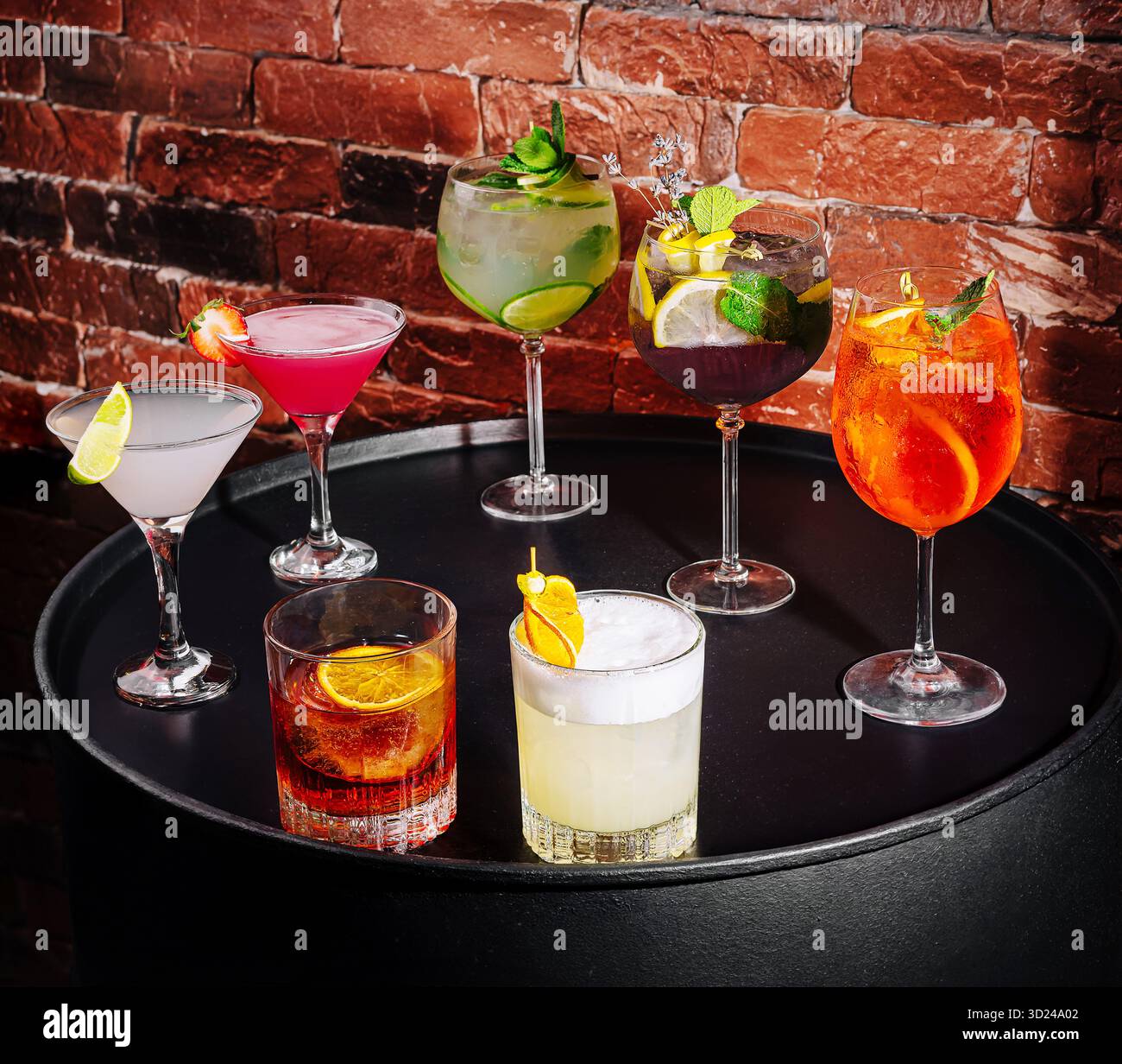 A variety of cocktails, including martinis and spritzers, are displayed ...