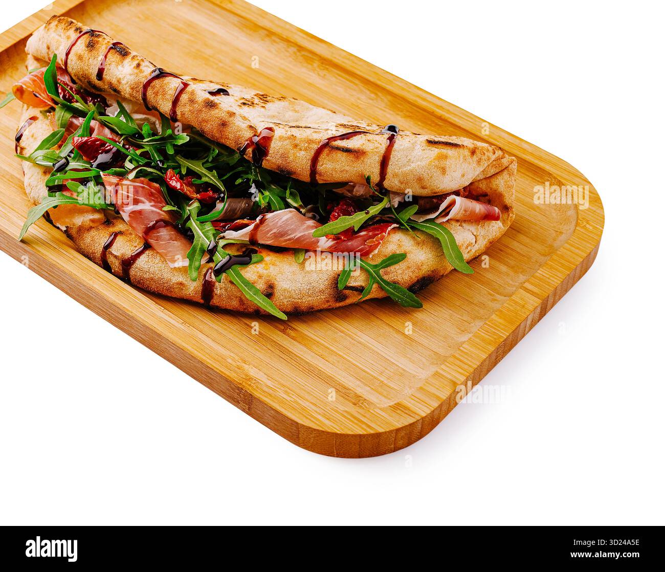 Delicious flatbread wrap filled with cured meats and fresh greens Stock ...