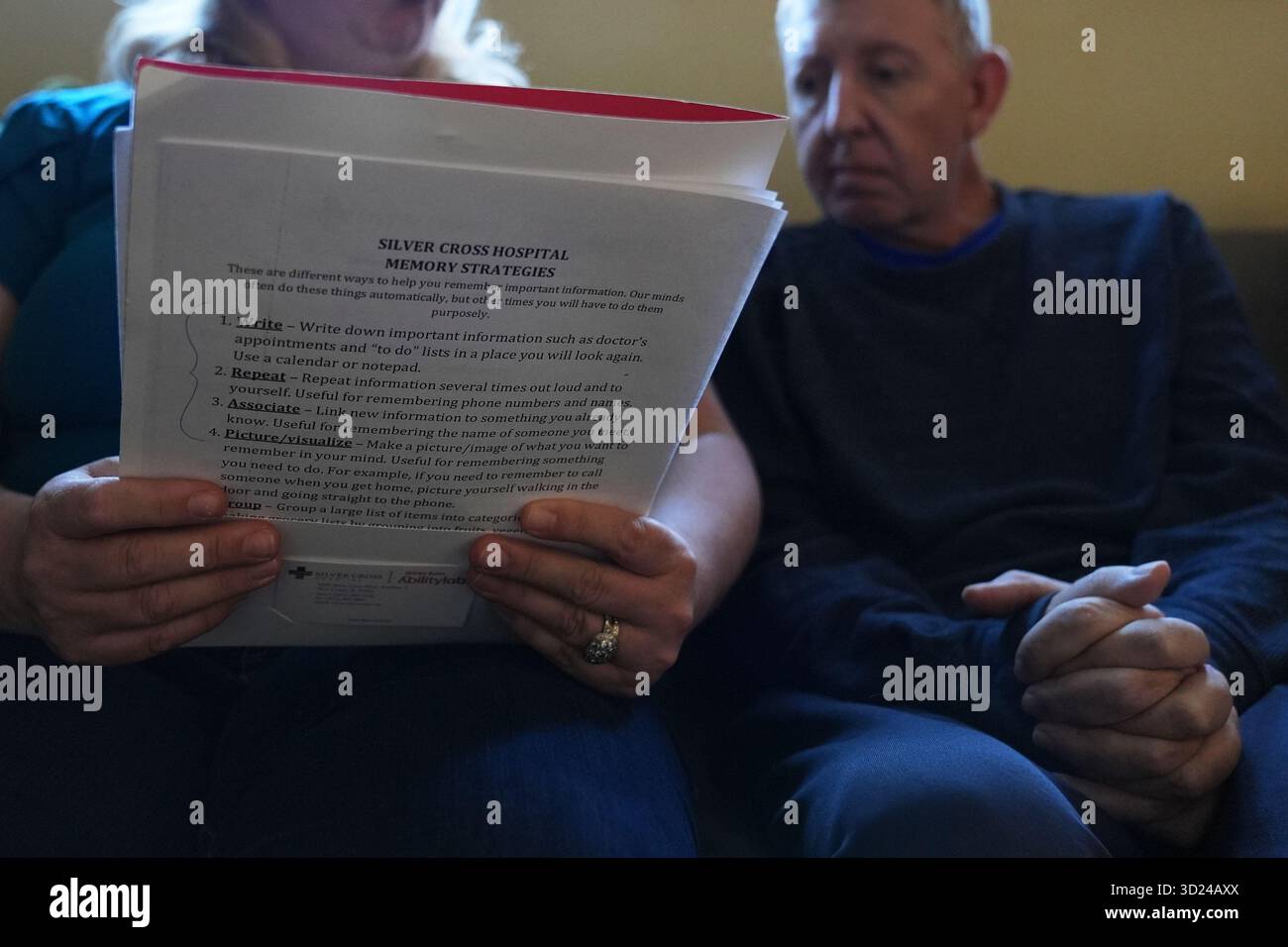 Bill Swick, right, studies with his wife Martha Swick at their home in ...