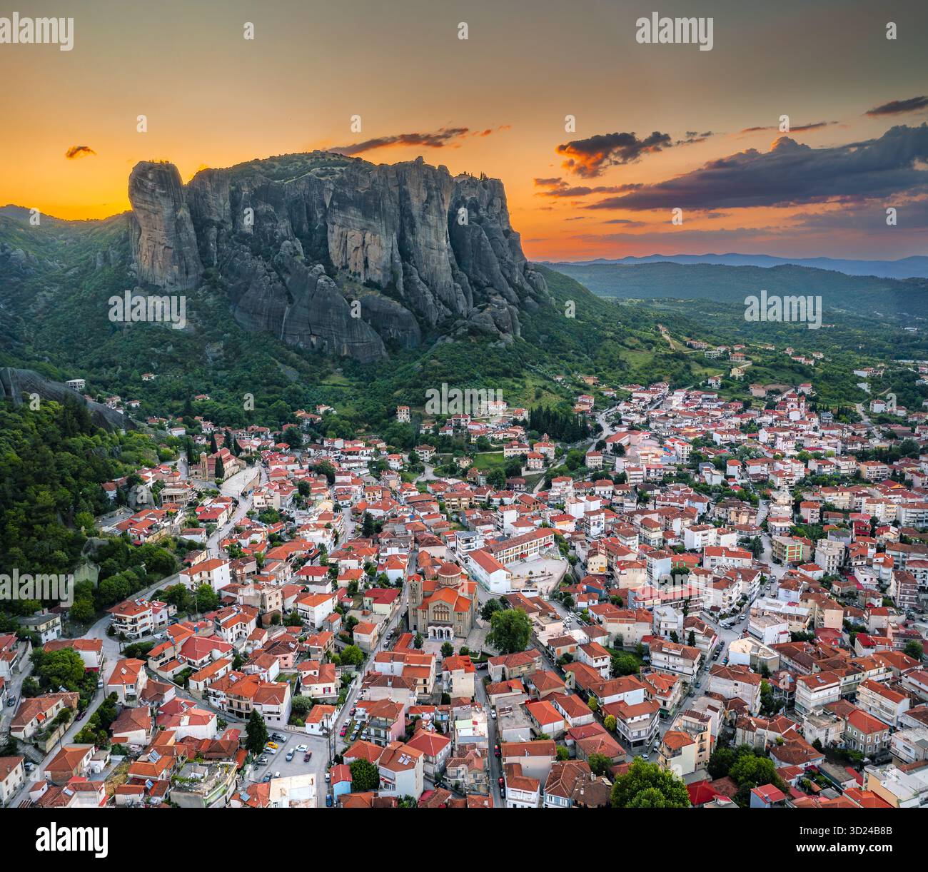 Aerial view of the town nestled below the imposing Meteora rock ...