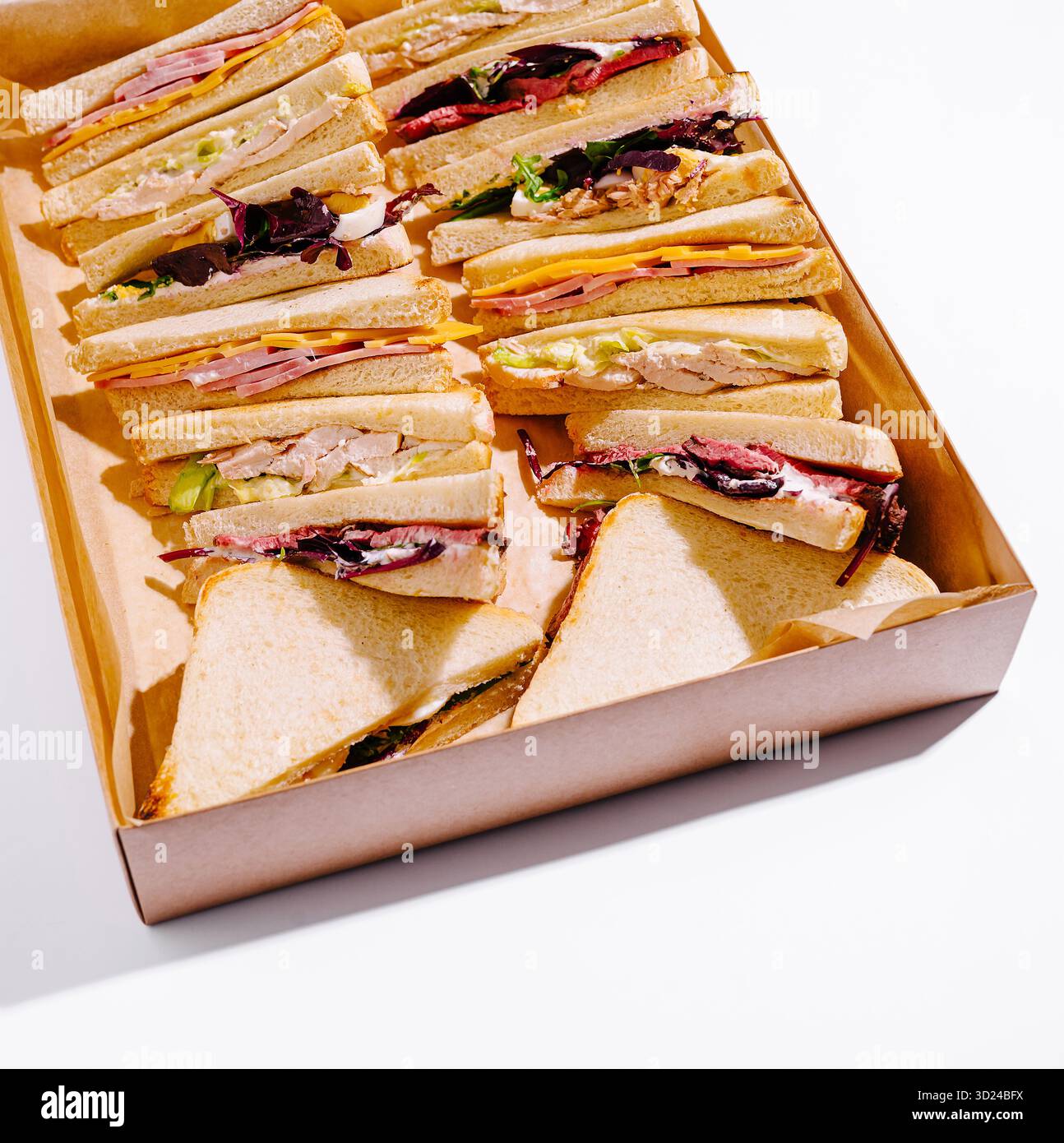 Various sandwiches arranged in a takeout box for a food display event ...