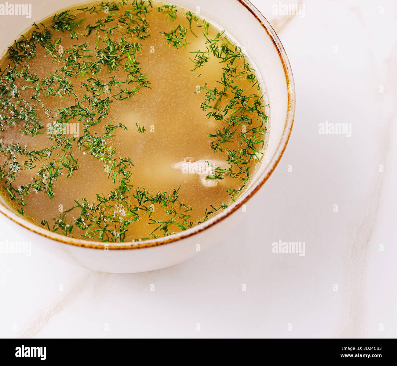Warm homemade broth with herbs and tender meat for a comforting meal ...