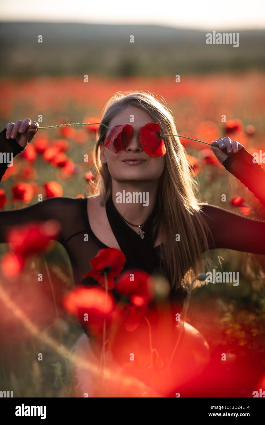 Poppy Flower Woman: Girl covers eyes with petals during daytime in ...