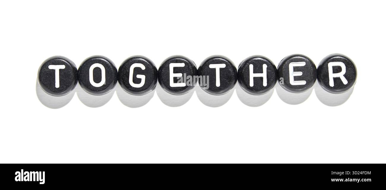Together word formed with black and white letter beads symbolizing ...
