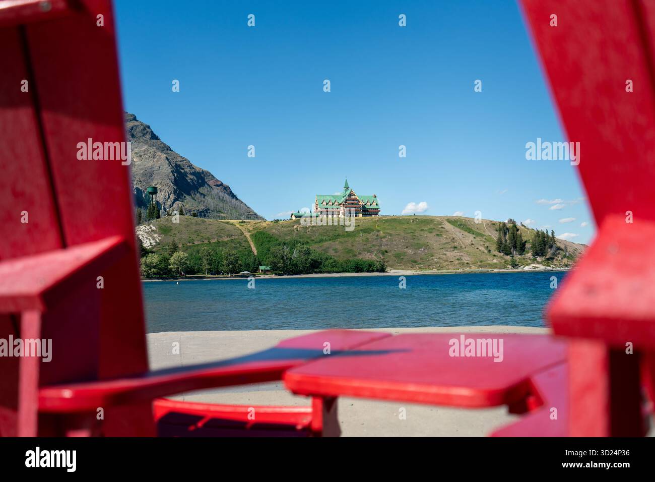 Mountain view from between two red chairs at lakeshore during daytime ...
