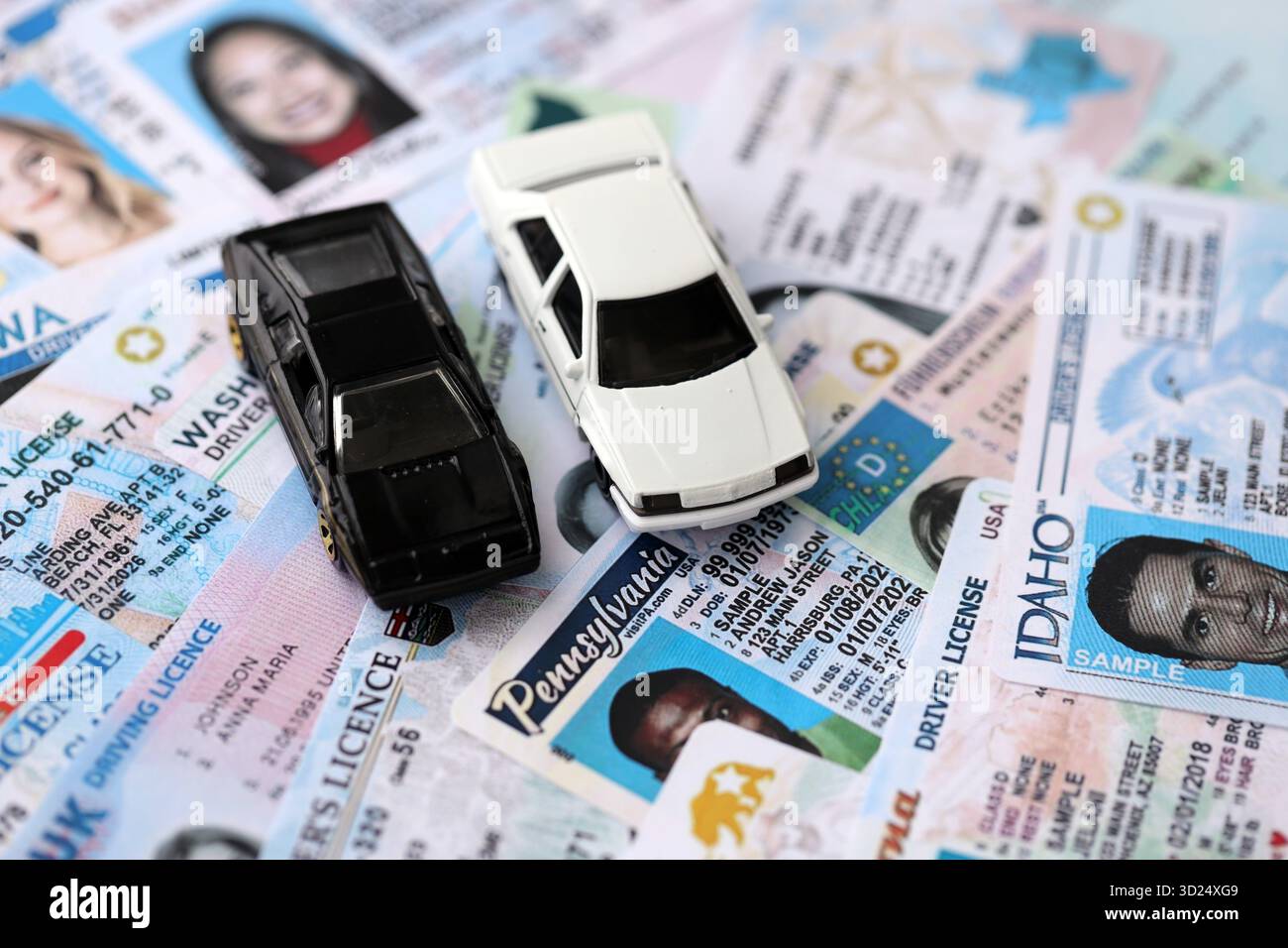KYIV, UKRAINE - OCTOBER 1, 2025 Toy cars on many driver license cards ...