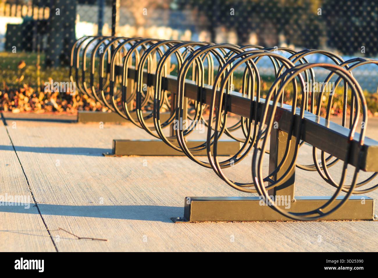 Bike parking racks in diminishing perspective with a fence in the ...