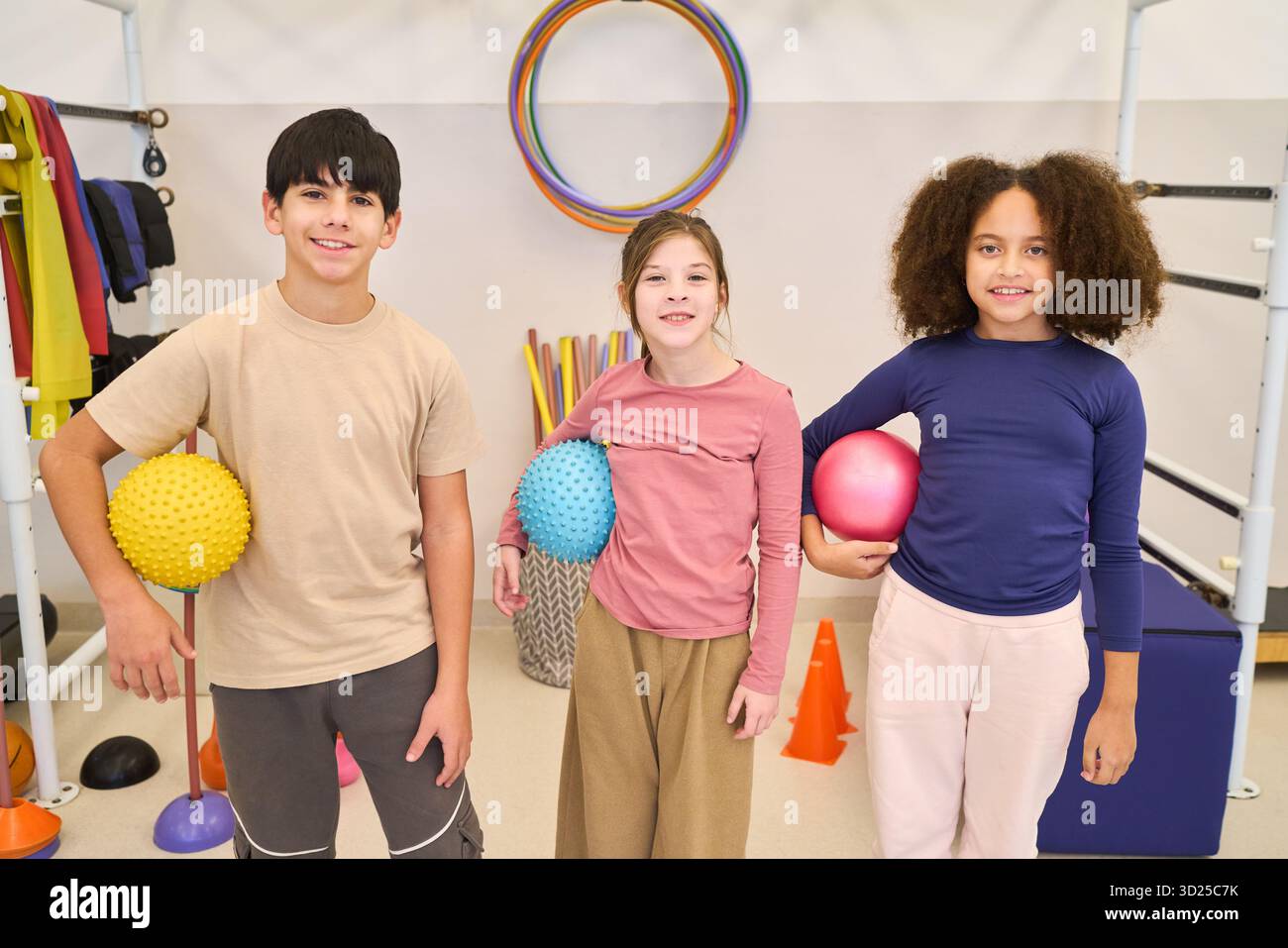 Three kids participate in a pediatric physiotherapy session at a rehab ...