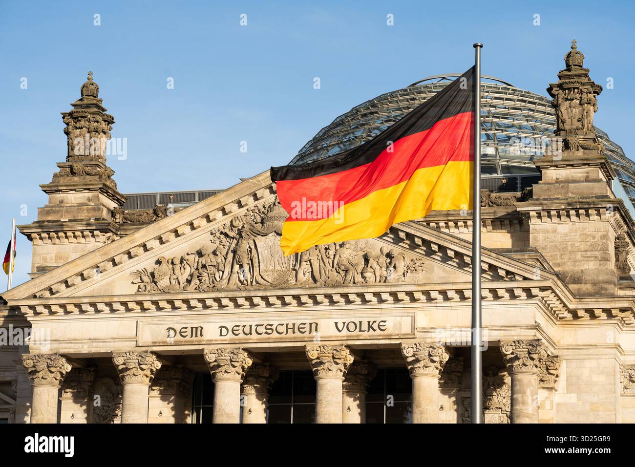 29 October 2025, Berlin: A German flag flies in front of the Reichstag ...