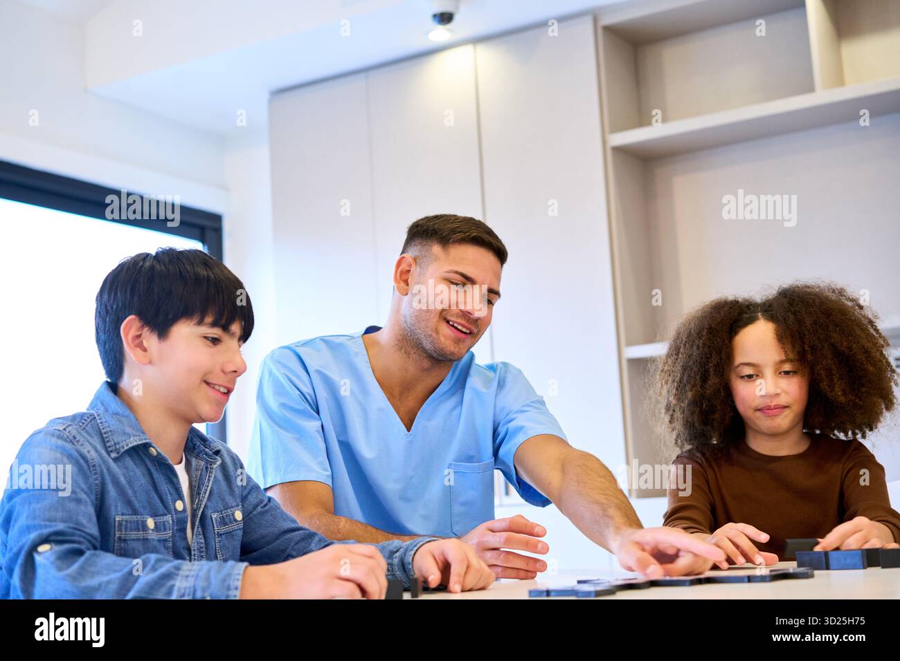 Caring therapist in blue hi-res stock photography and images - Alamy