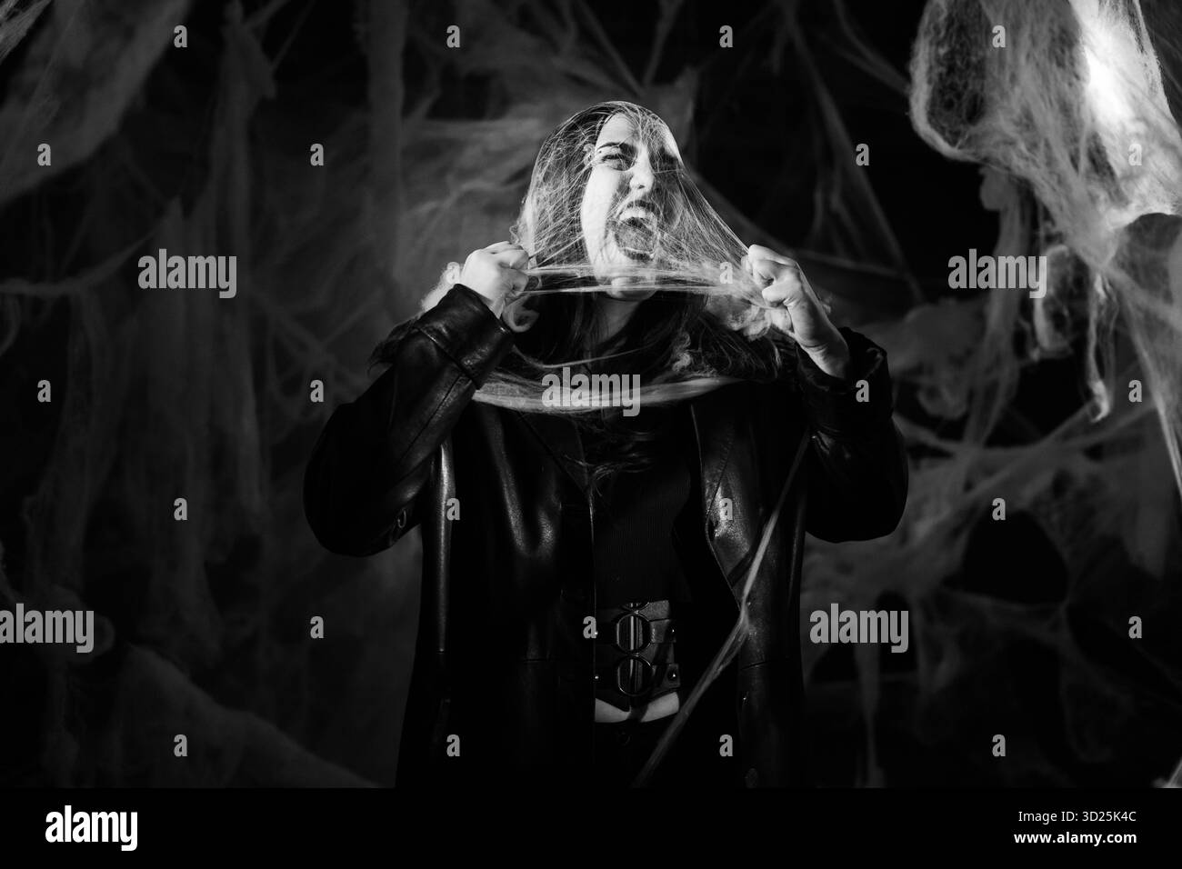 Sinister woman with Halloween vampire makeup trapped in spider web ...