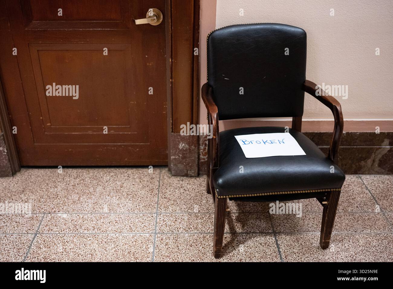 UNITED STATES - OCTOBER 30: A chair with a "broken" sign sits in a ...
