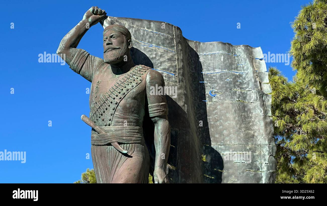 Heroic bronze statue of Spyros Kayales raising the Greek flag at ...