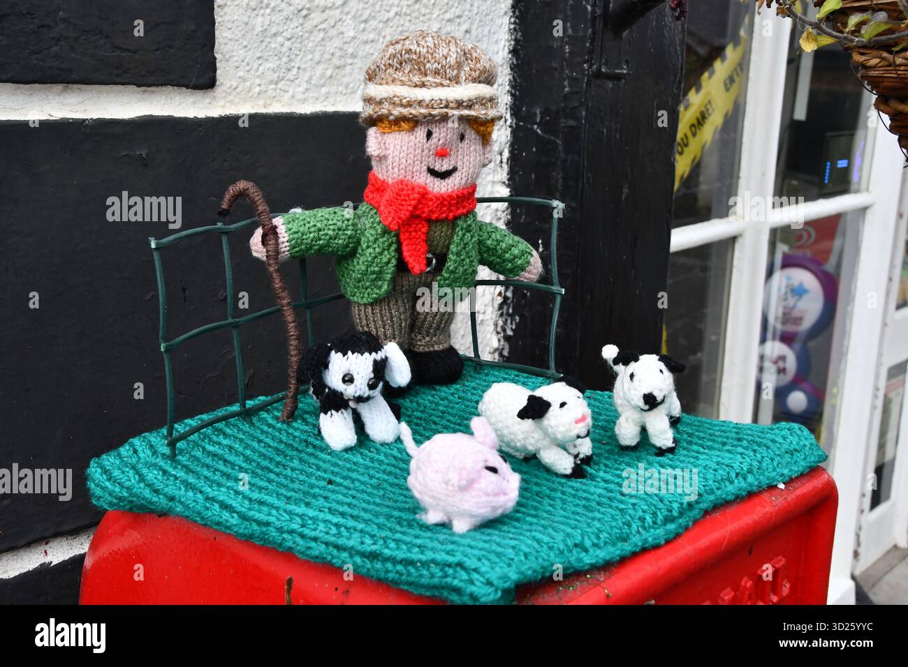 Knitted cap for postbox in Wales featuring a shepherd, sheep and his ...