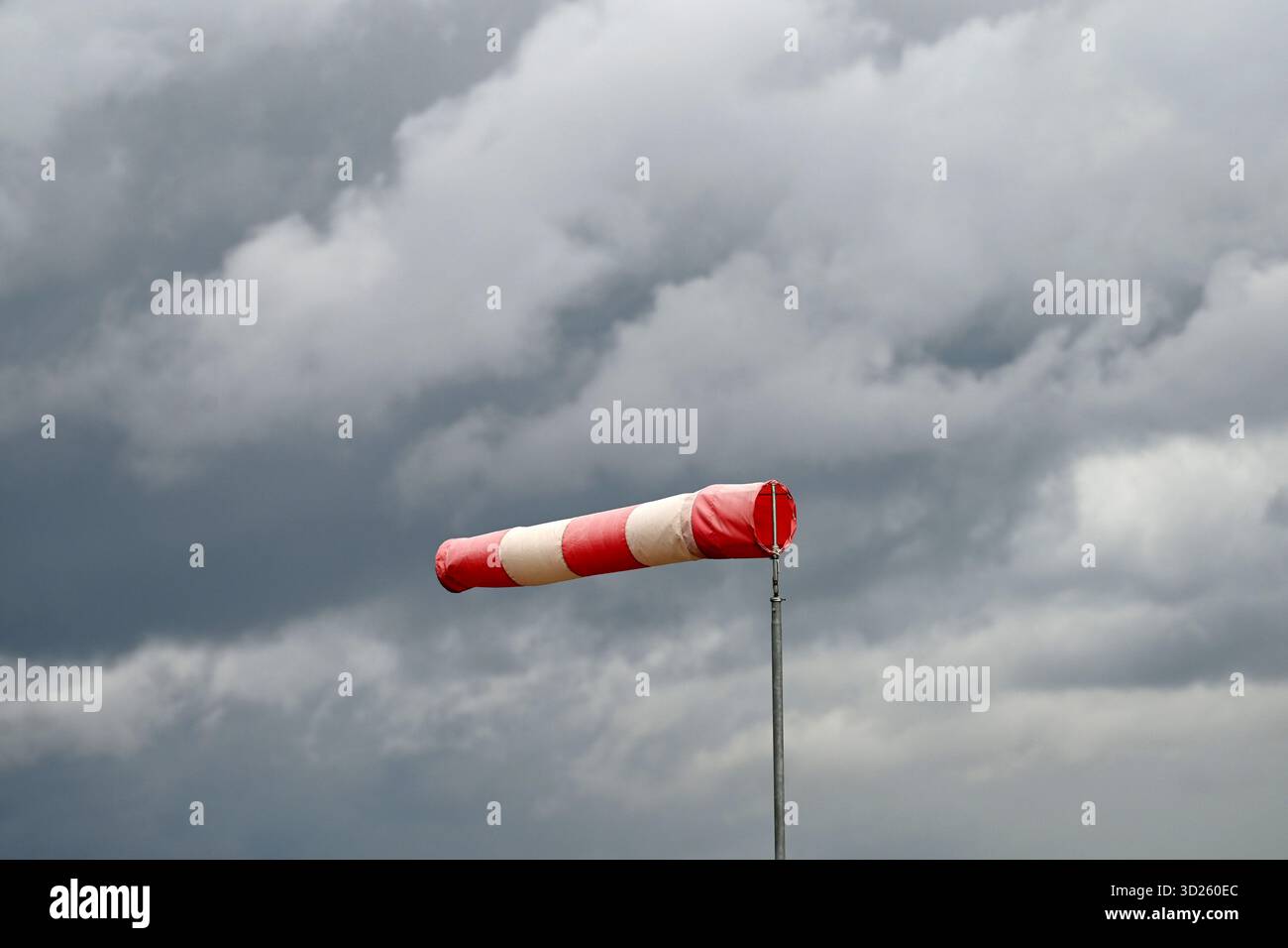 Striped windsock in the wind, clouds, weather image, storm, severe ...