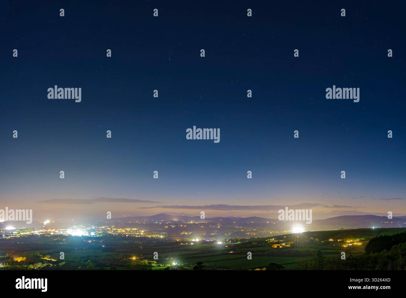 Comet C/2025 A6 Lemmon visible above illuminated valley, southeast of ...