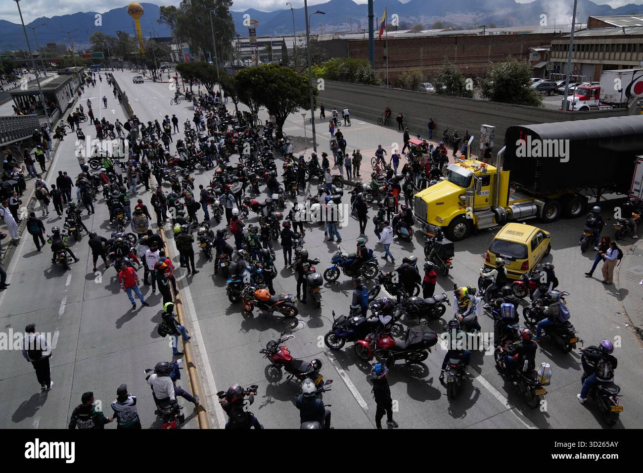 Motorcyclists block a street during a protest against a decree issued ...