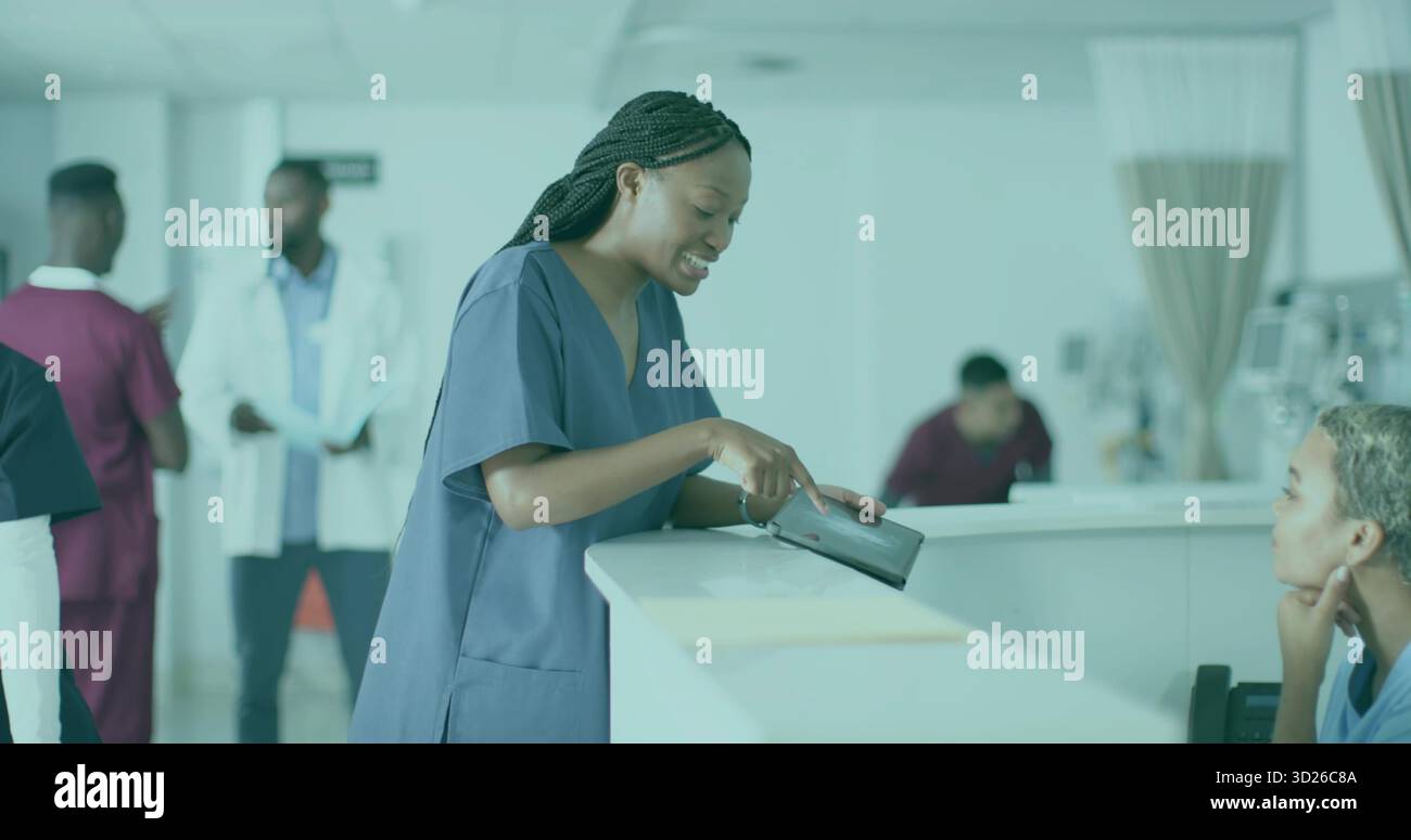 Pointing female nurse wearing navy scrubs consulting patient at ...
