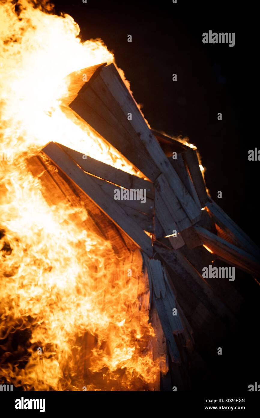 A wolf effigy is burned and illuminates the night sky at a fire ...