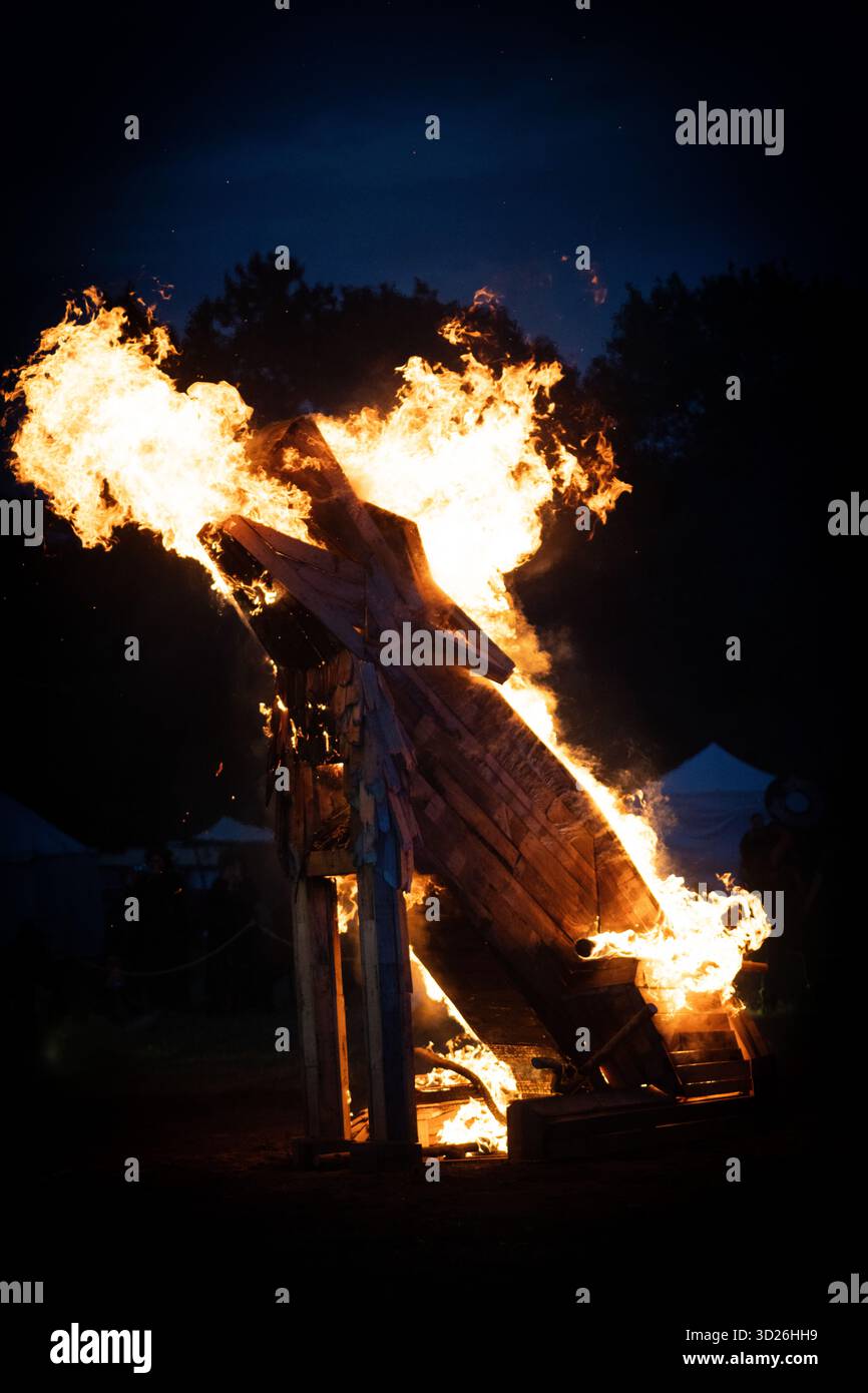 A wolf effigy is burned and illuminates the night sky at a fire ...