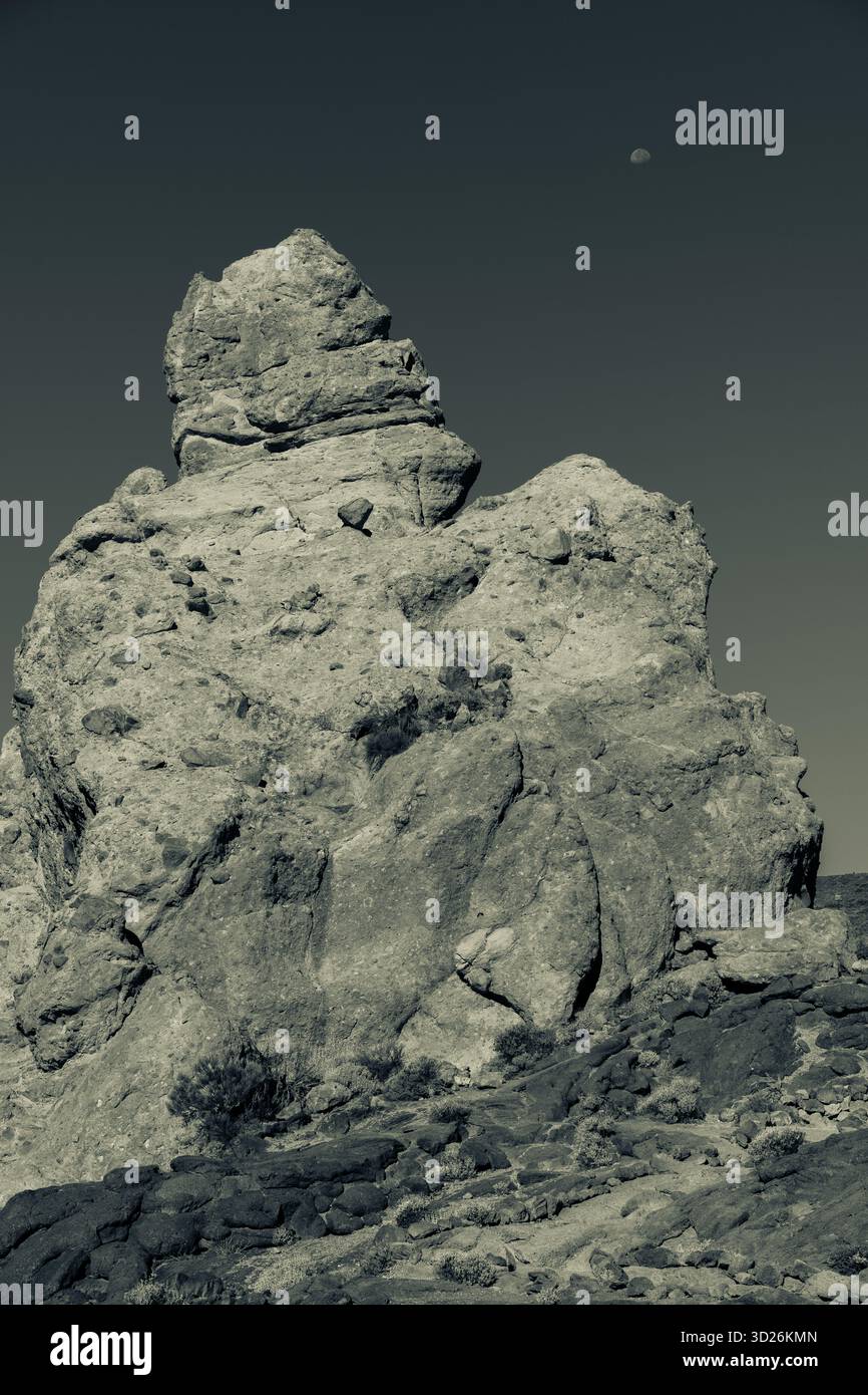 Black and white image of a tall jagged rock pinnacle rising against a ...
