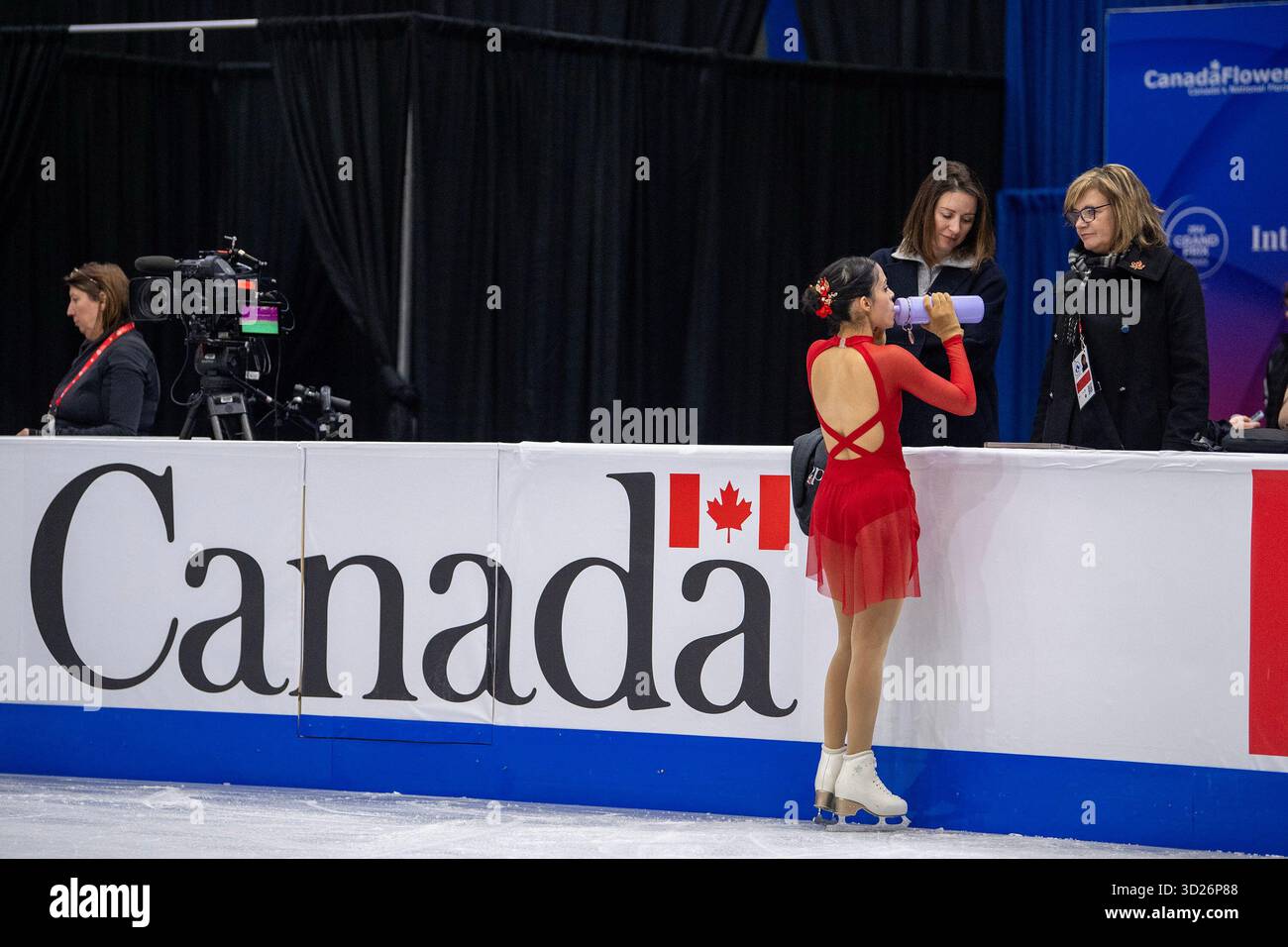 Canadian ice dancer Madeline Schizas speaks to coaches during a ...