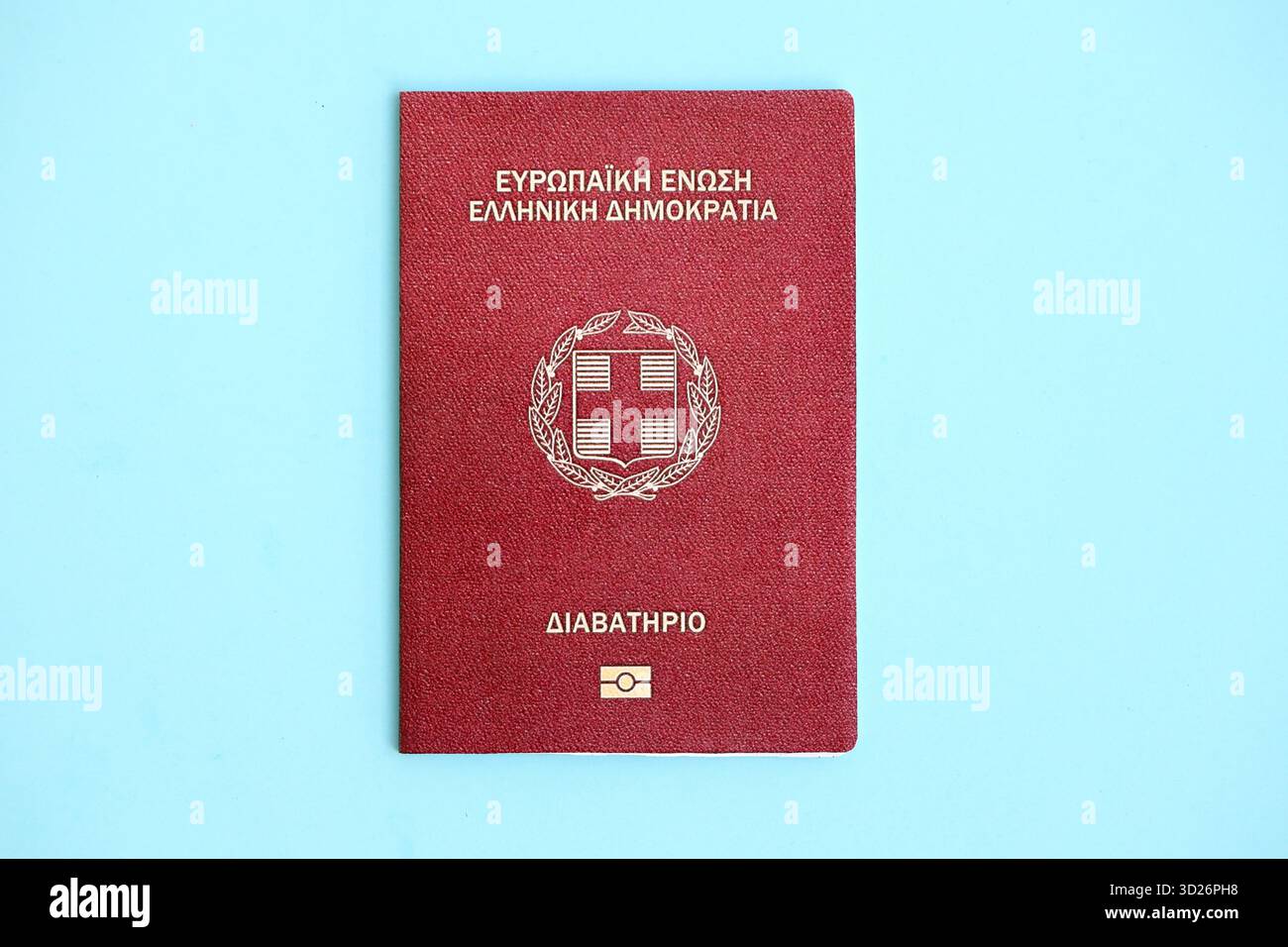 Greece passport on light blue paper background close up. Citizenship ...