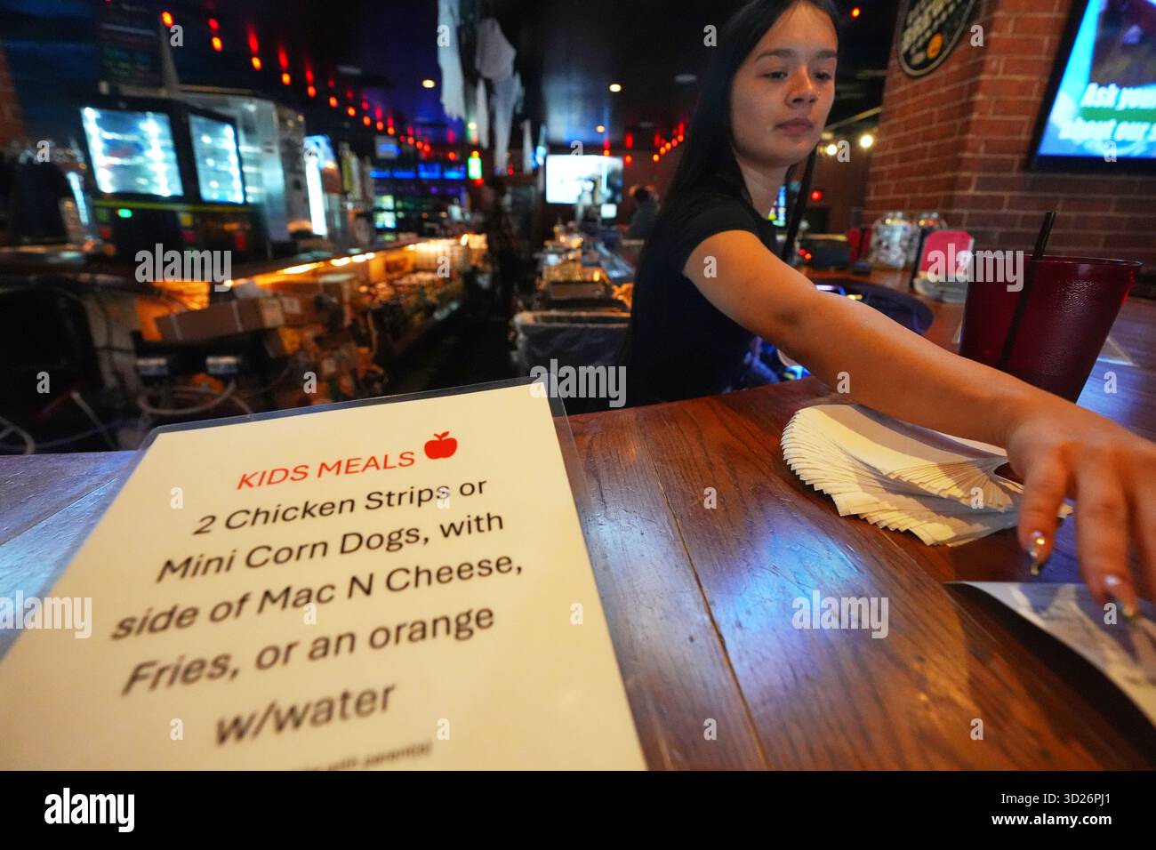 Katie Pham works while a free kids menu is displayed for SNAP ...