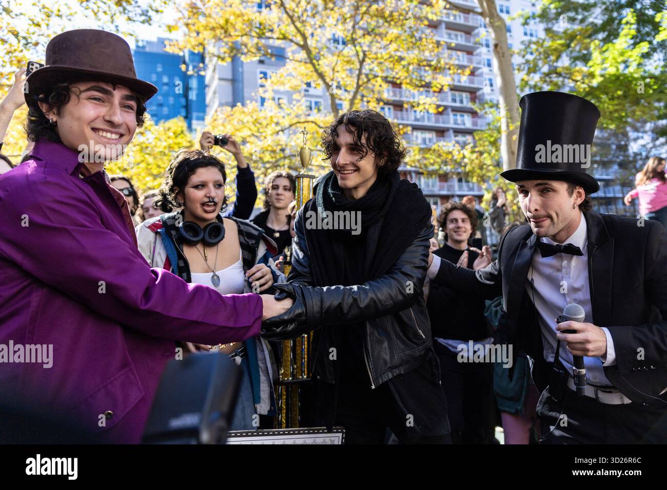 FILE - Miles Mitchell, left and Zander Dueve, center, shake hands at ...