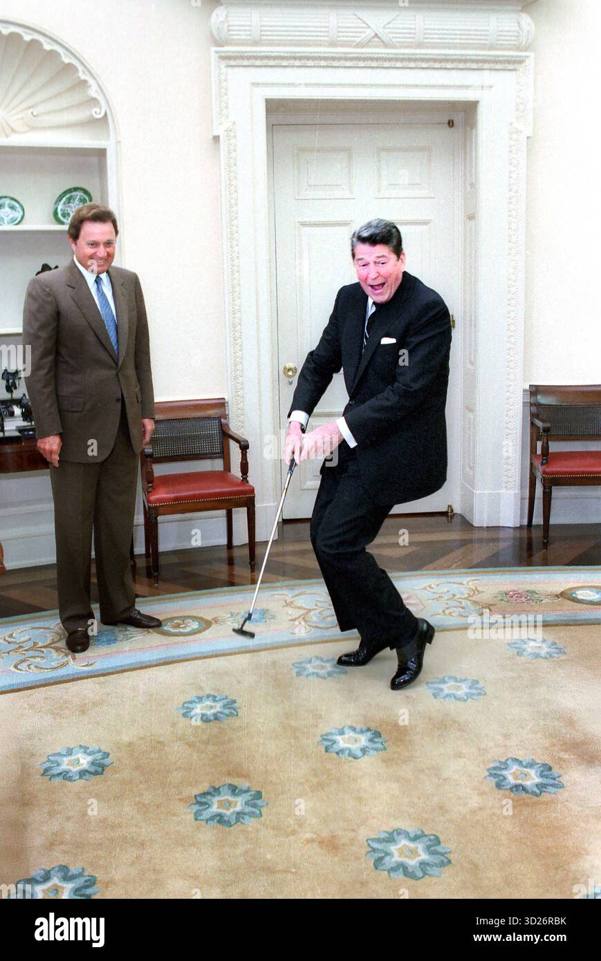 U.S. President Ronald Reagan putting a golf ball with American ...