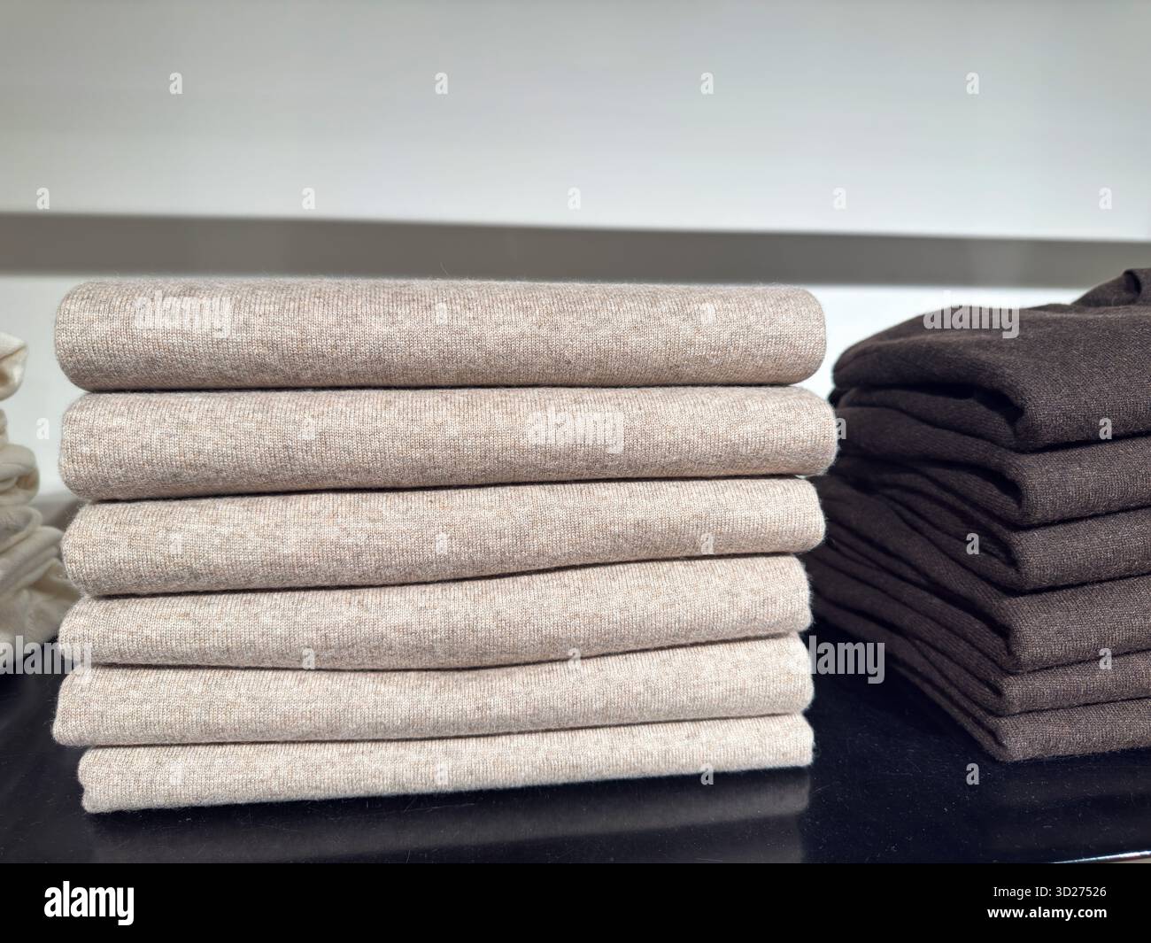 Luxury winter cashmere sweater neatly folded on shelf Stock Photo - Alamy
