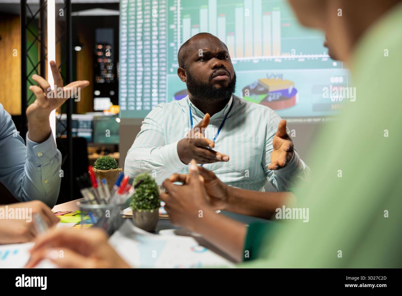 African american worried CEO addressing business issues in a late night ...