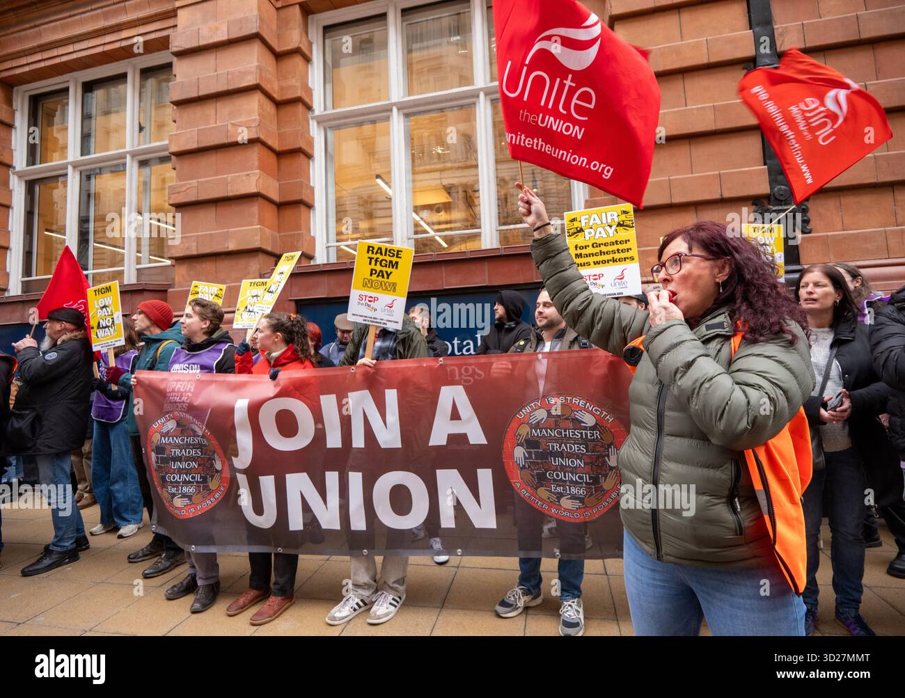 Manchester, UK. 30th Oct, 2025. Protesters hold a banner and placards ...