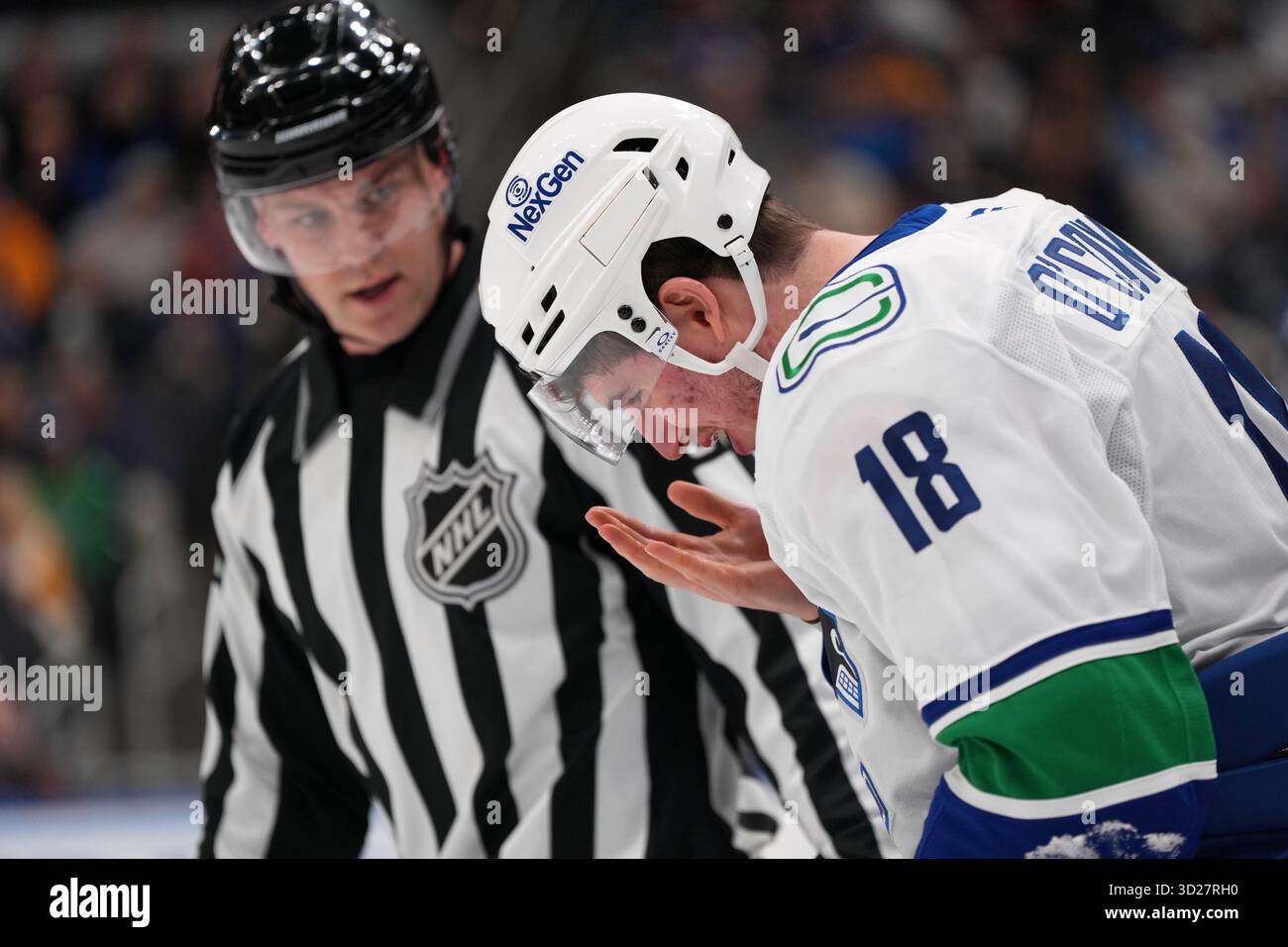 Vancouver Canucks' Drew O'Connor (18) skates off the ice after being ...