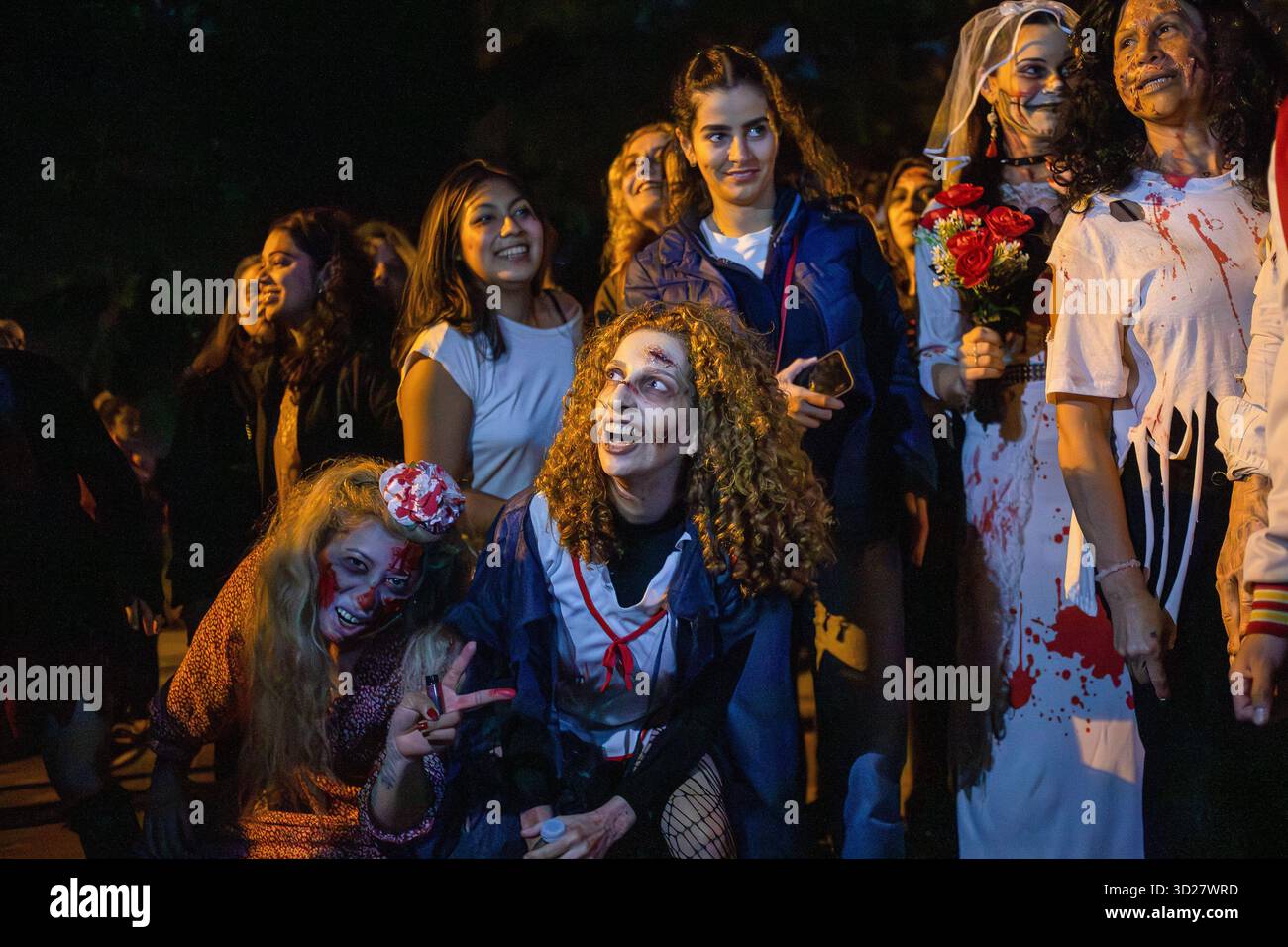 A group of people dressed as zombies are seen during a flash mob at El ...