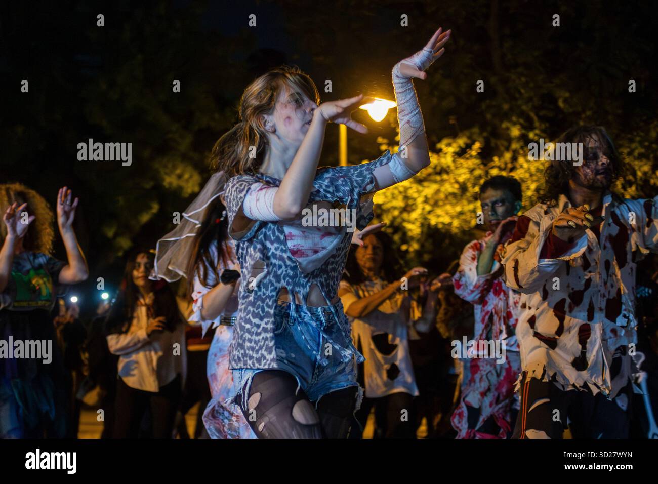 A woman dressed as a zombie dances during a flash mob at El Retiro Park ...