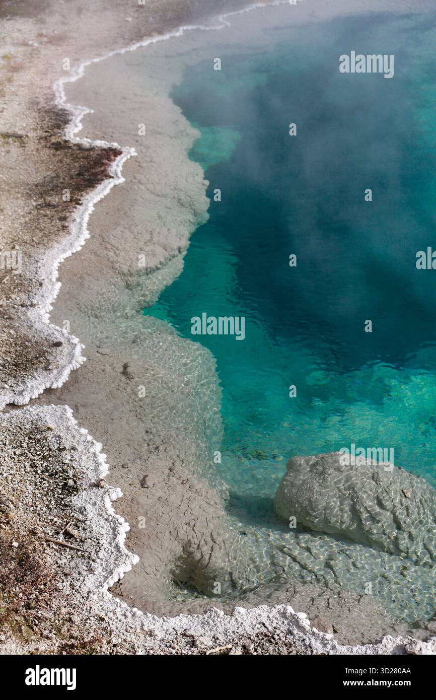 This scene showcases a beautiful blue hot spring surrounded by unique ...