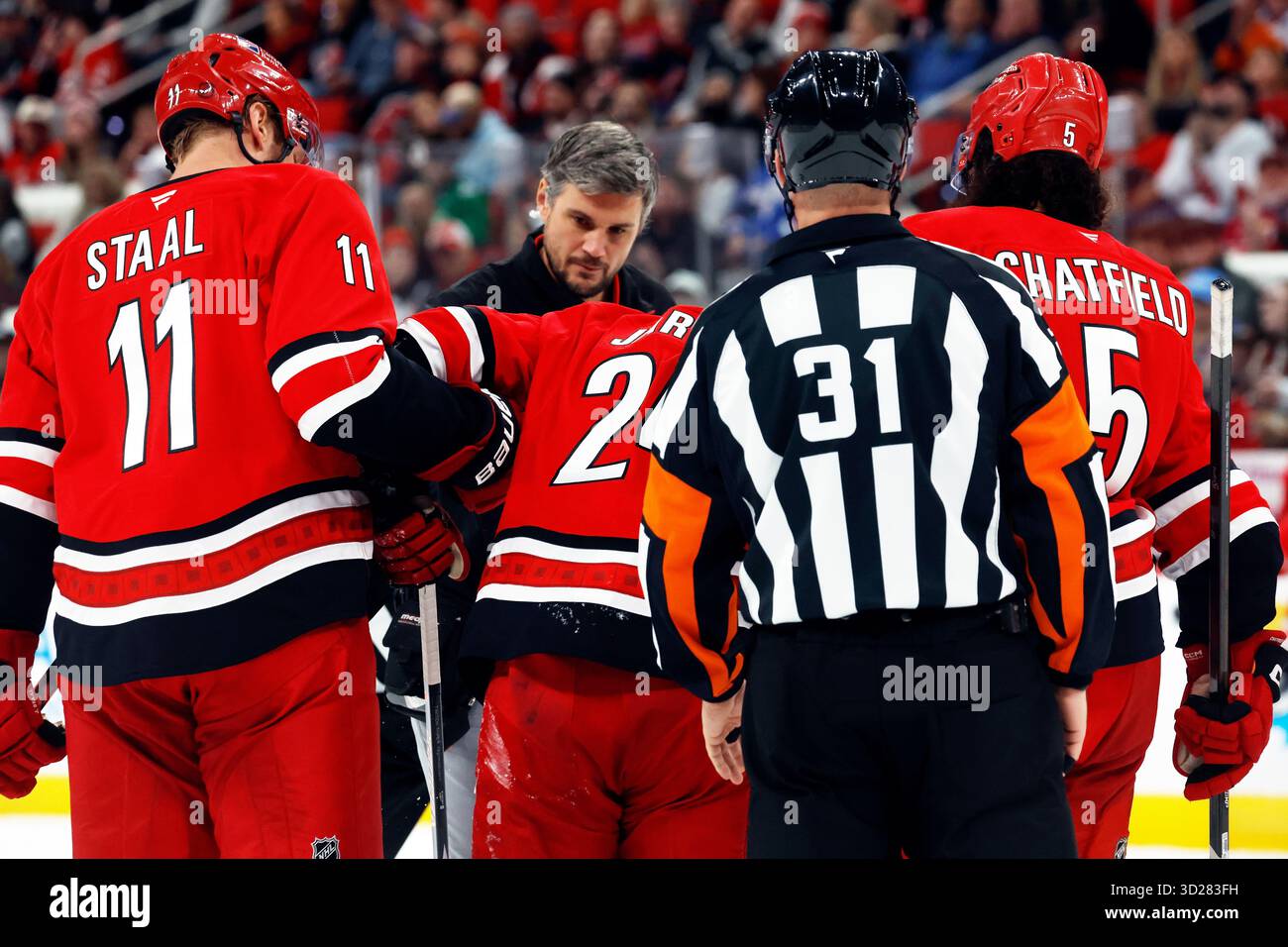 Carolina Hurricanes Head Athletic Trainer Doug Bennett, center, tends ...