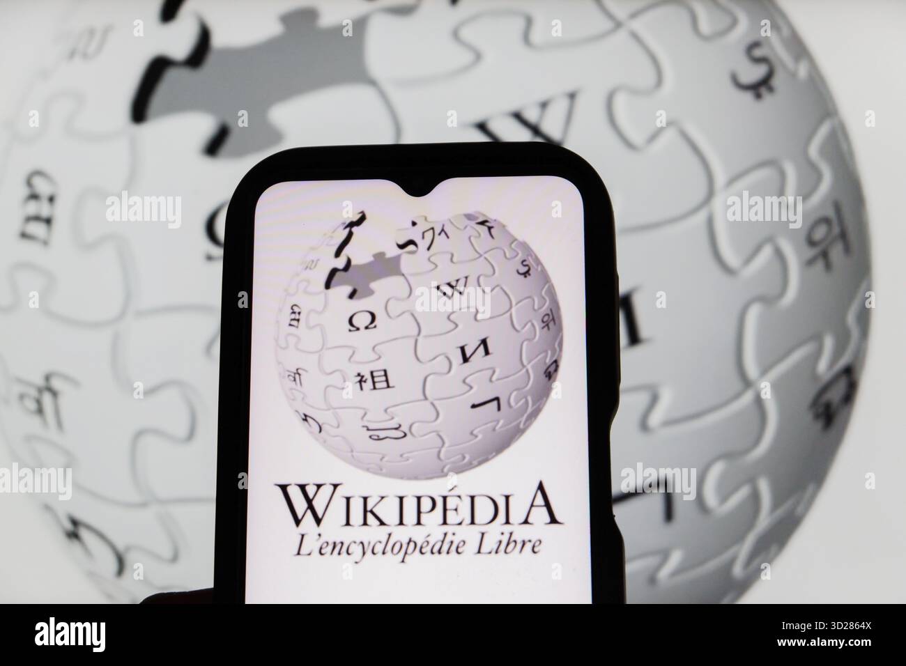 In this photo illustration, a Wikipedia logo is displayed on a ...