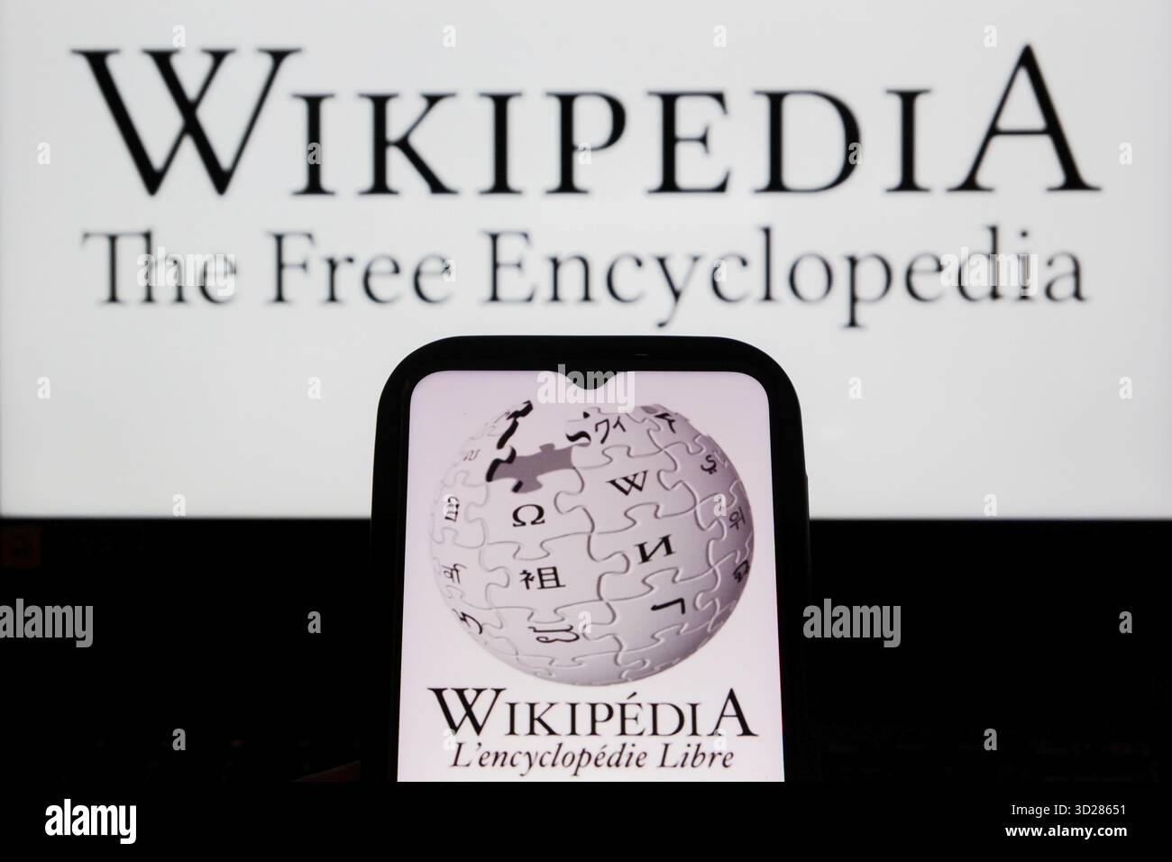 In this photo illustration, a Wikipedia logo is displayed on a ...