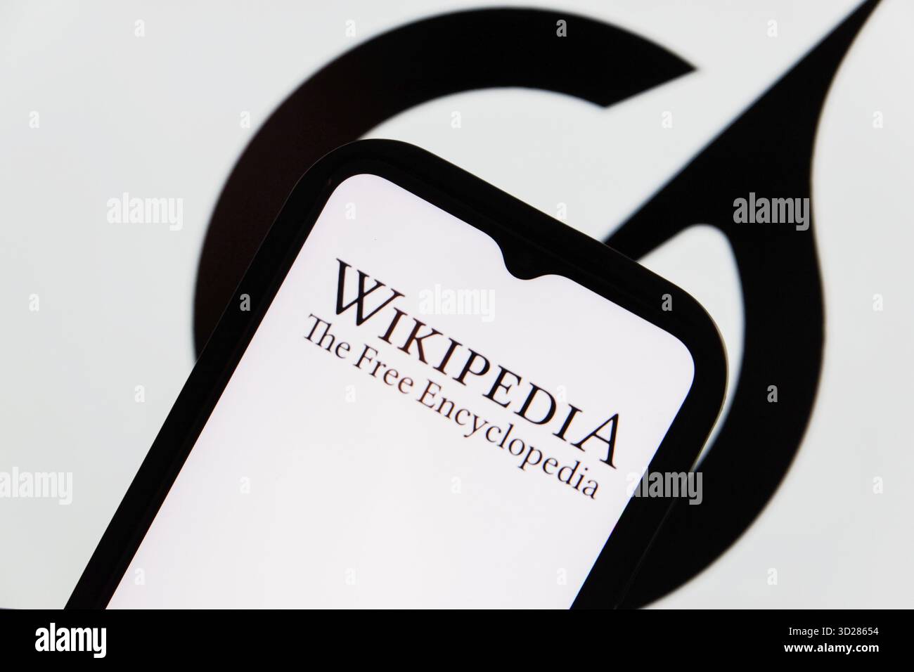 In this photo illustration, a Wikipedia logo is displayed on a ...