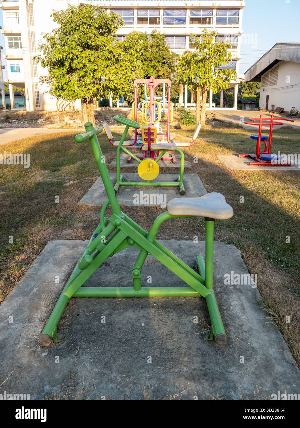 Colorful playground equipment in a primary school yard during sunny day ...