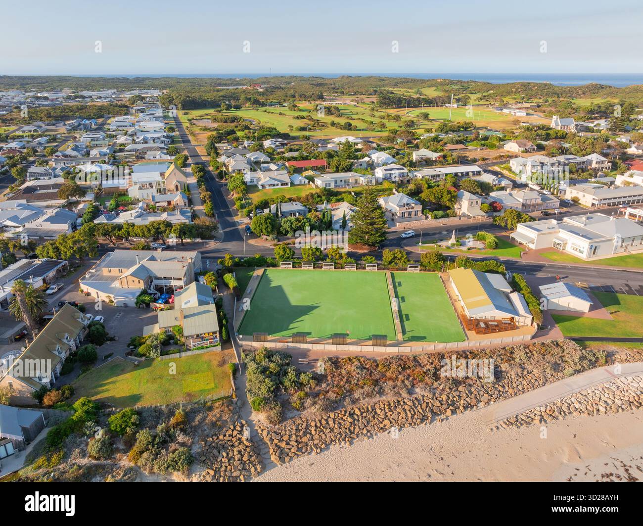 Aerial view of a bowling green alongside a sandy beach in a coastal ...