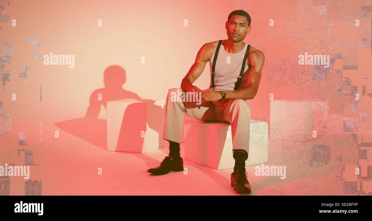 Posing man wearing white tank top on three white cube blocks in studio ...