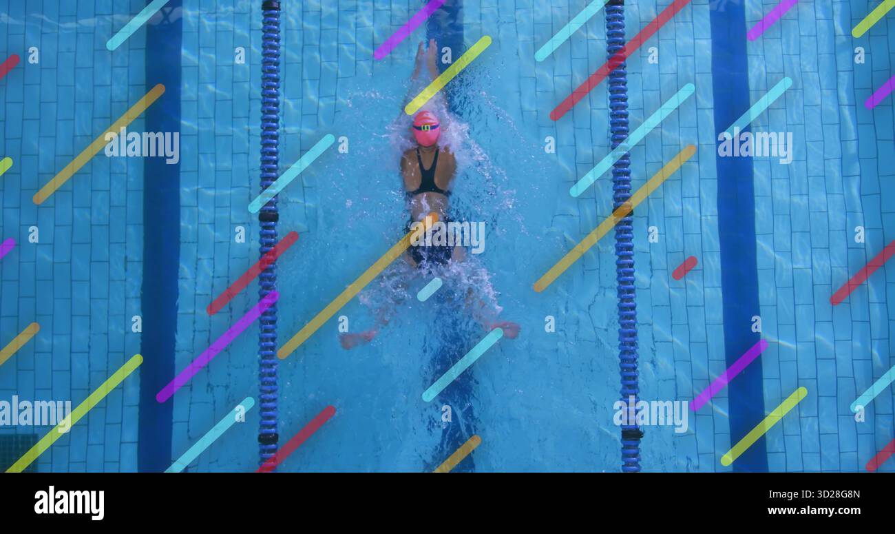 Slicing female swimmer cutting through pool lanes at aquatic center ...