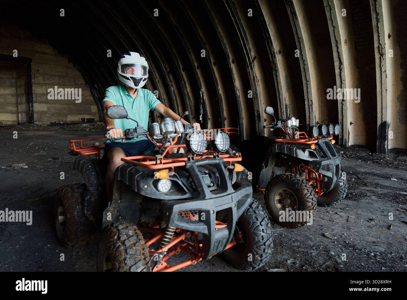 Riding ATVs in an abandoned building during daylight hours Stock Photo ...