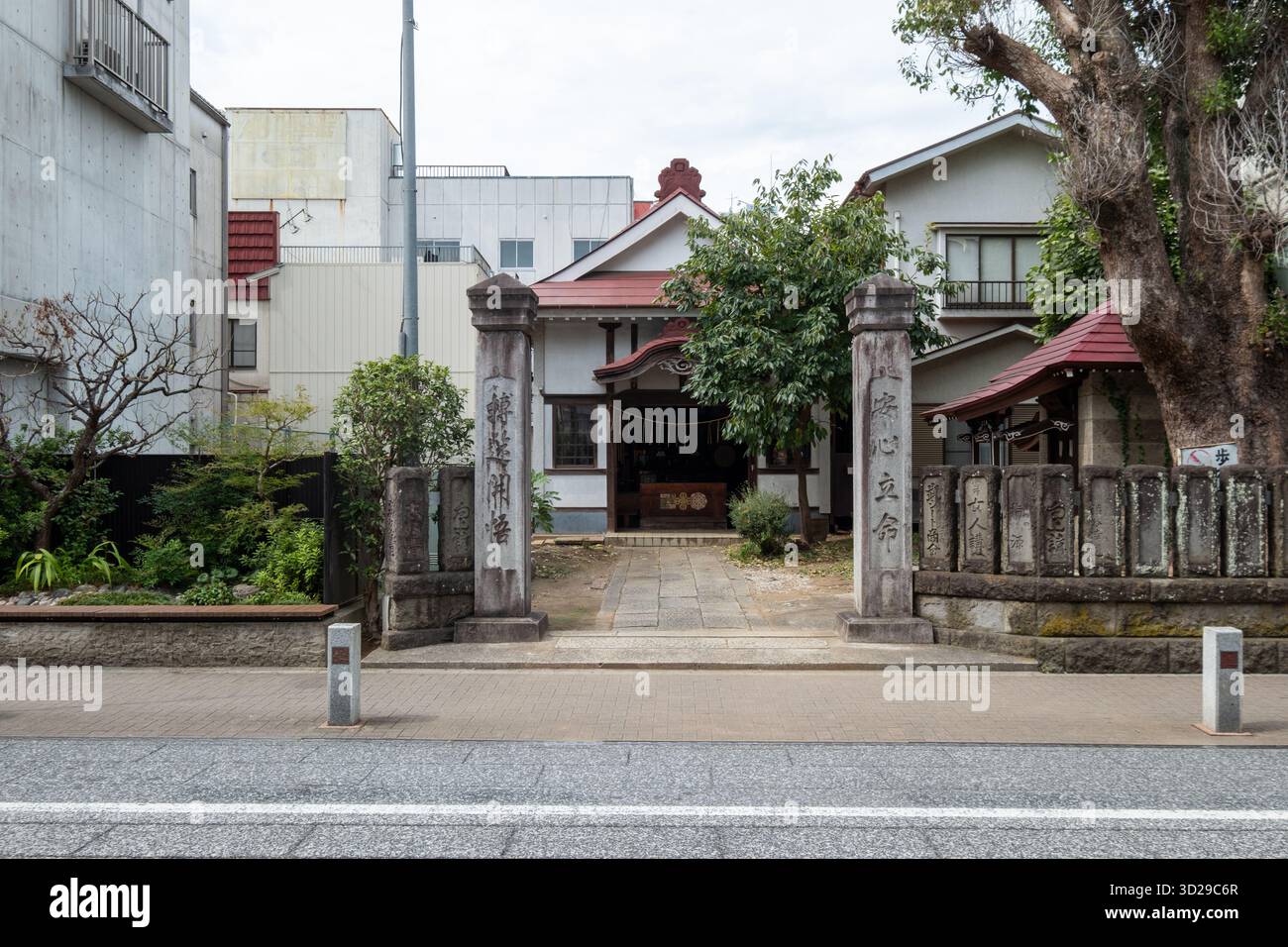 View of an ornate Daishido Temple entrance with stone pillars framing ...