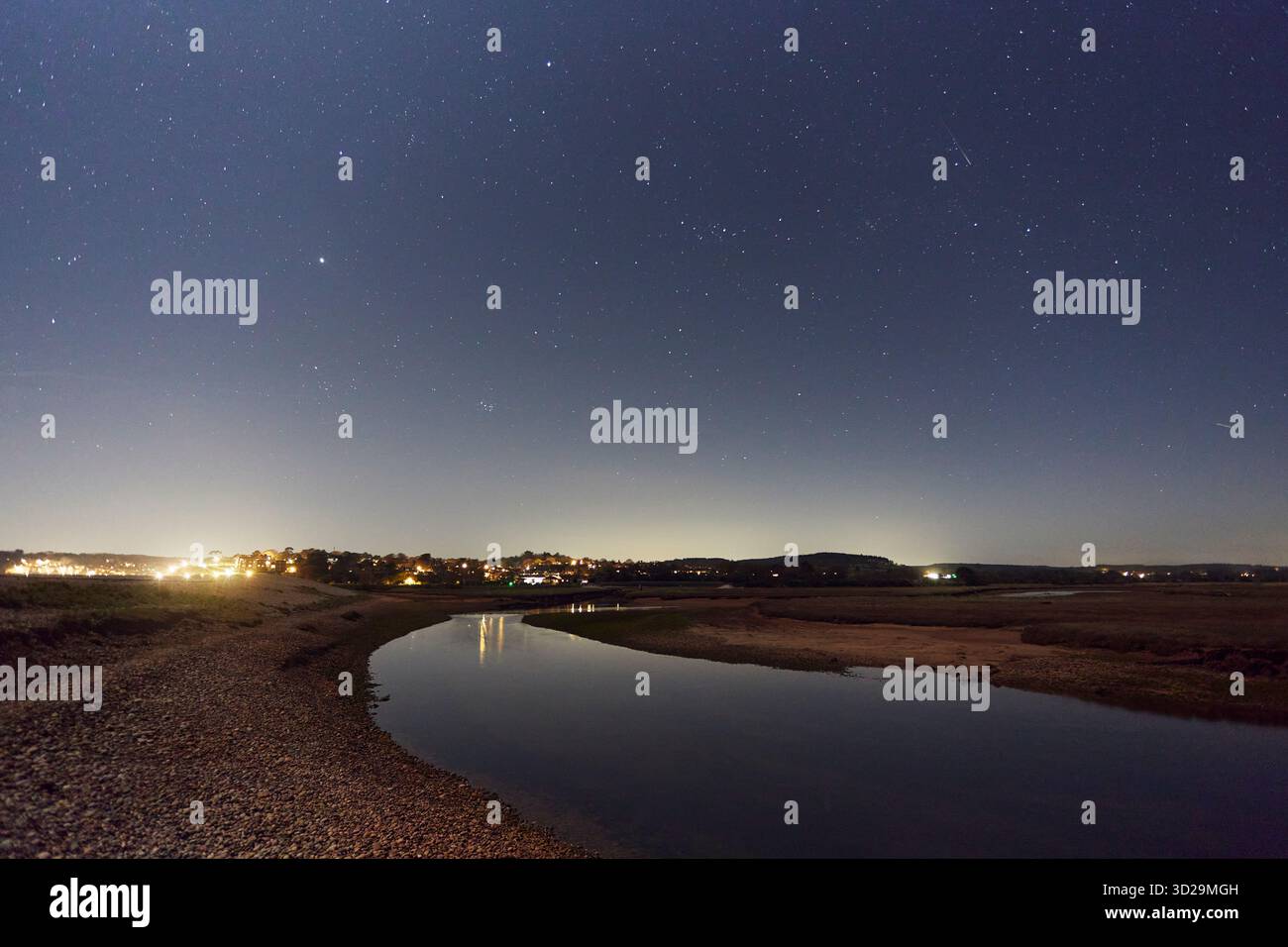 A starry night sky over a river estuary; River Otter,t Budleigh ...